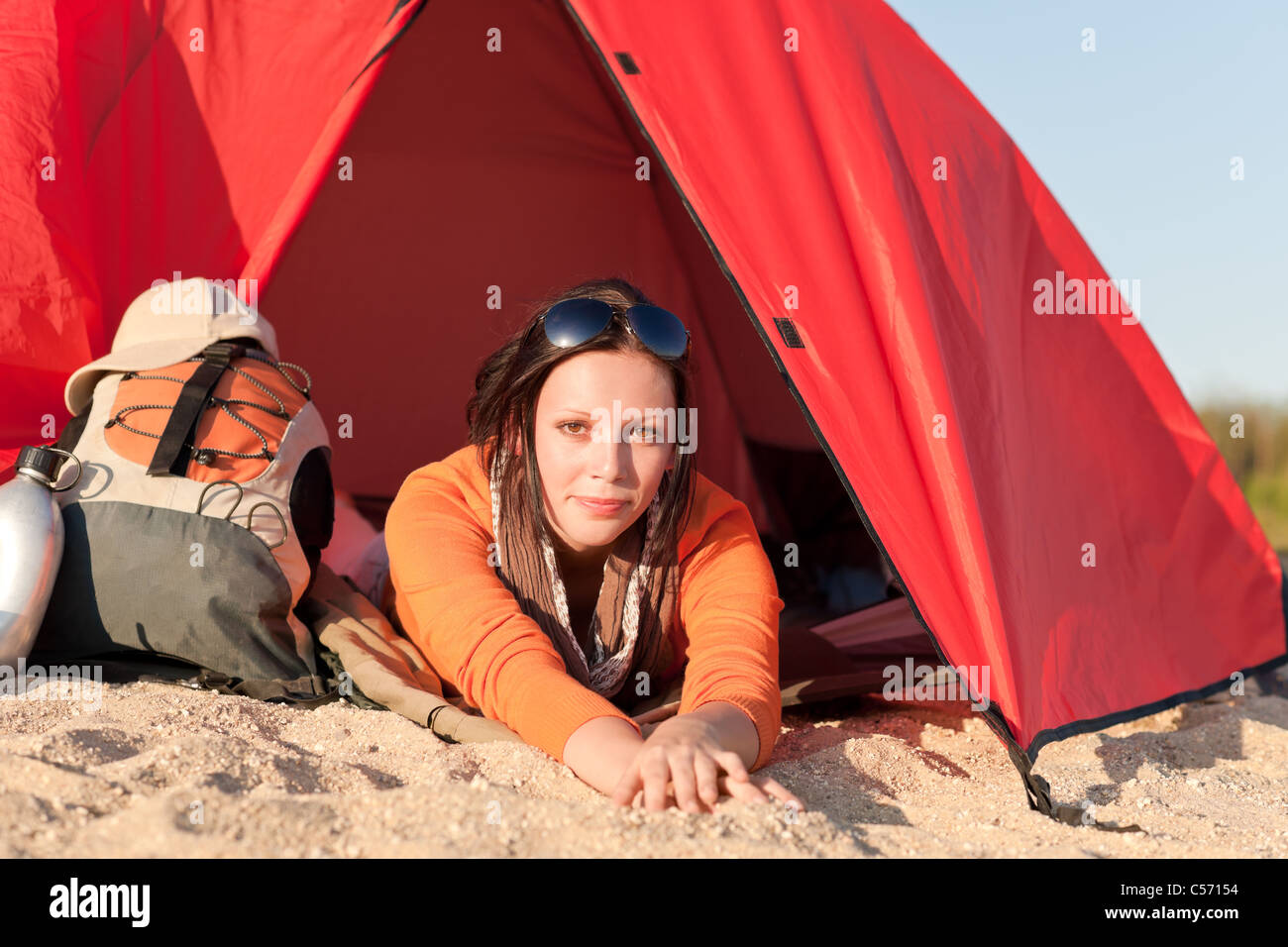 Beautiful happy woman camping lying and relaxing in tent Stock Photo ...