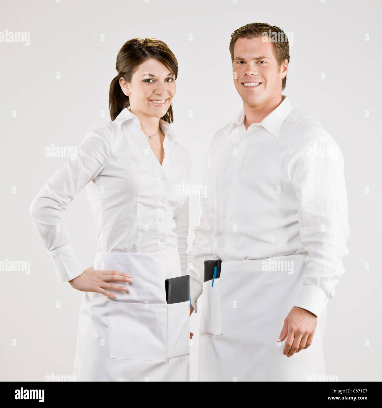 Servers wearing aprons with checks Stock Photo - Alamy