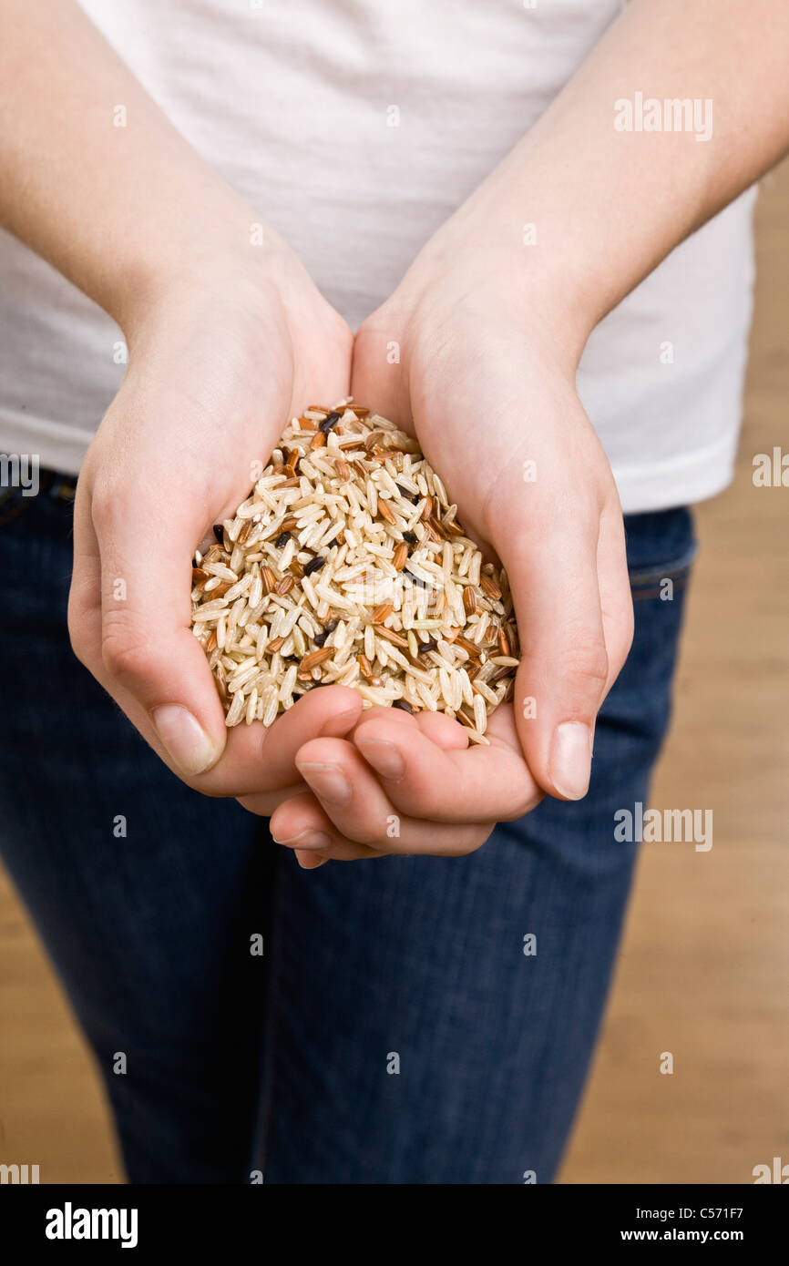 Woman holding handful of wild rice Stock Photo - Alamy