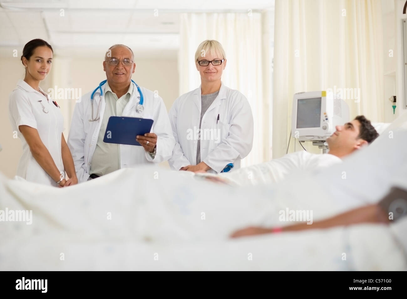 Doctors and nurse in hospital room Stock Photo - Alamy