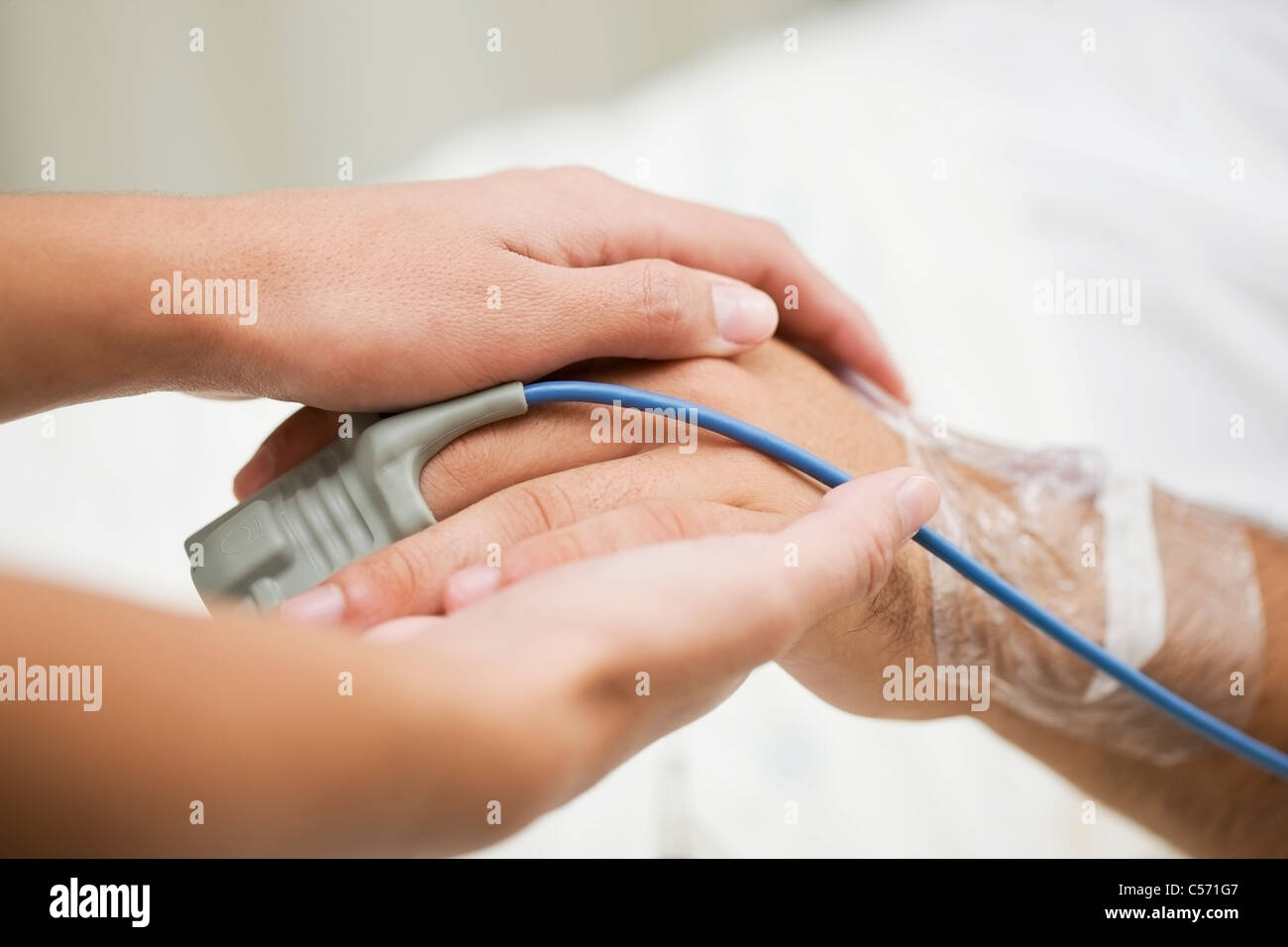 Person holding hospital patient’s hand Stock Photo - Alamy