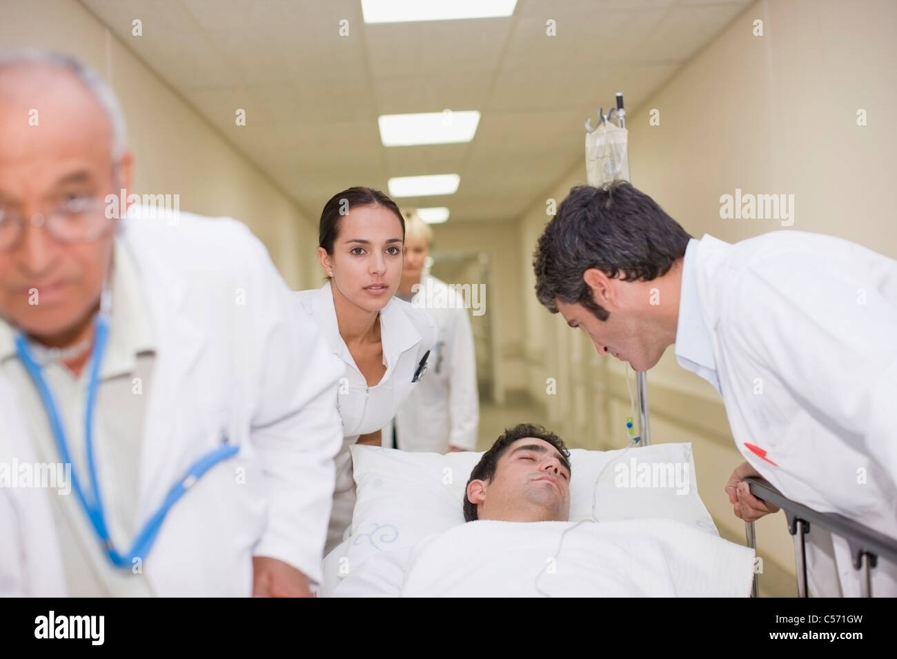 Doctors rushing down hospital corridor hi-res stock photography and ...