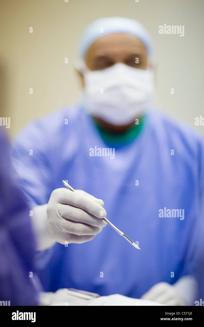 Surgeon holding scalpel Stock Photo - Alamy