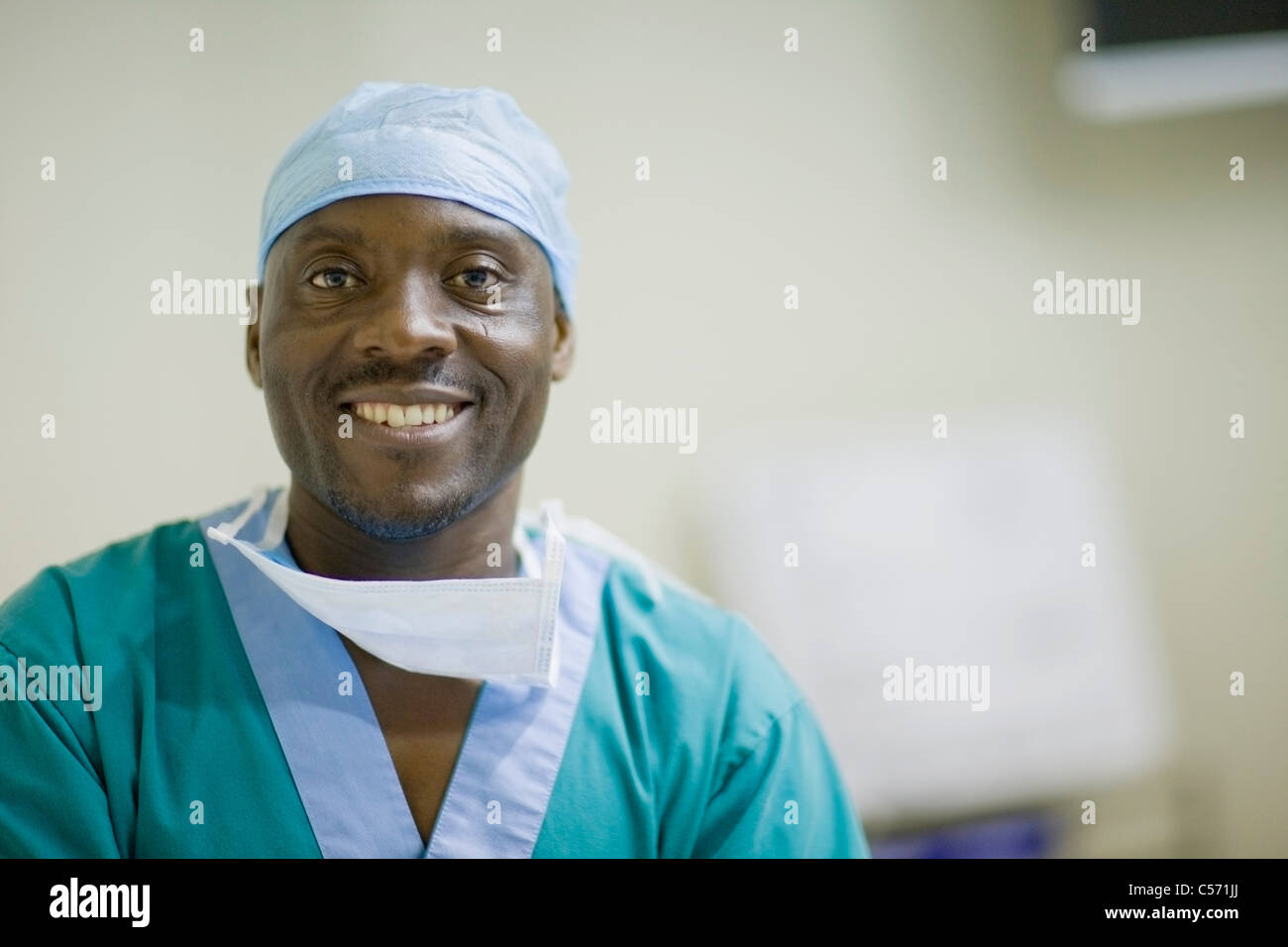 Smiling doctor with loosened mask Stock Photo - Alamy