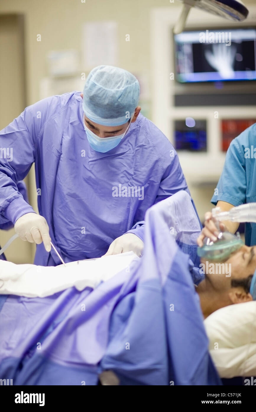 Doctor performing operation Stock Photo - Alamy