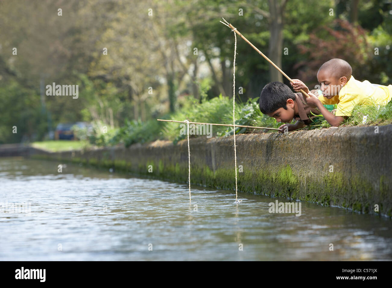 Kid fishing on riverbank hi-res stock photography and images - Alamy