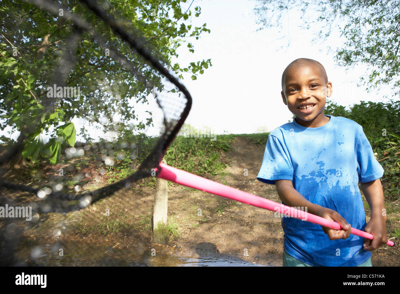 Boy playing with fishing net Stock Photo - Alamy