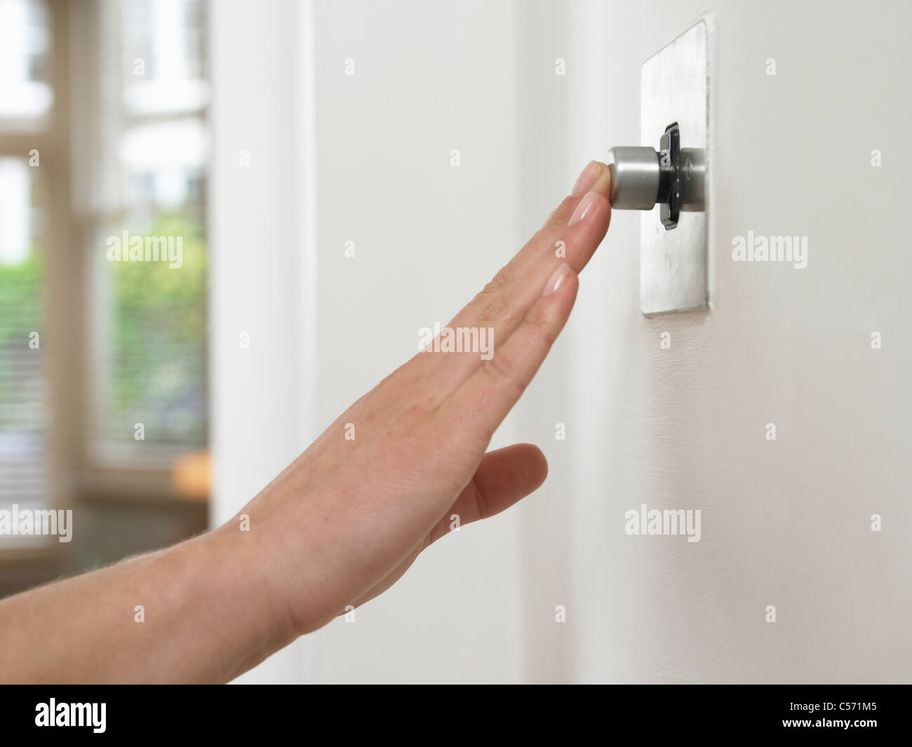 Woman pressing button on wall Stock Photo - Alamy Woman pressing button on wall Stock Photo - Alamy