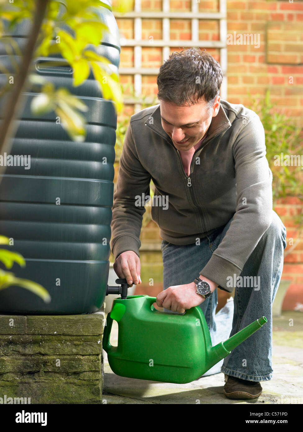 Man filling jug with recycled water Stock Photo - Alamy