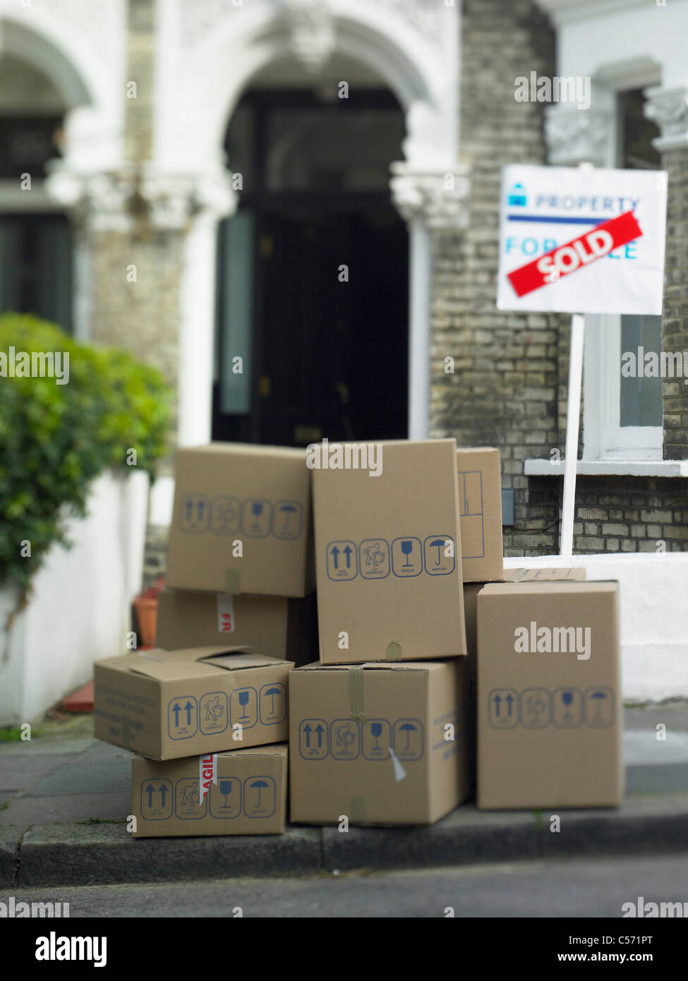 Cardboard boxes outside new home Stock Photo - Alamy