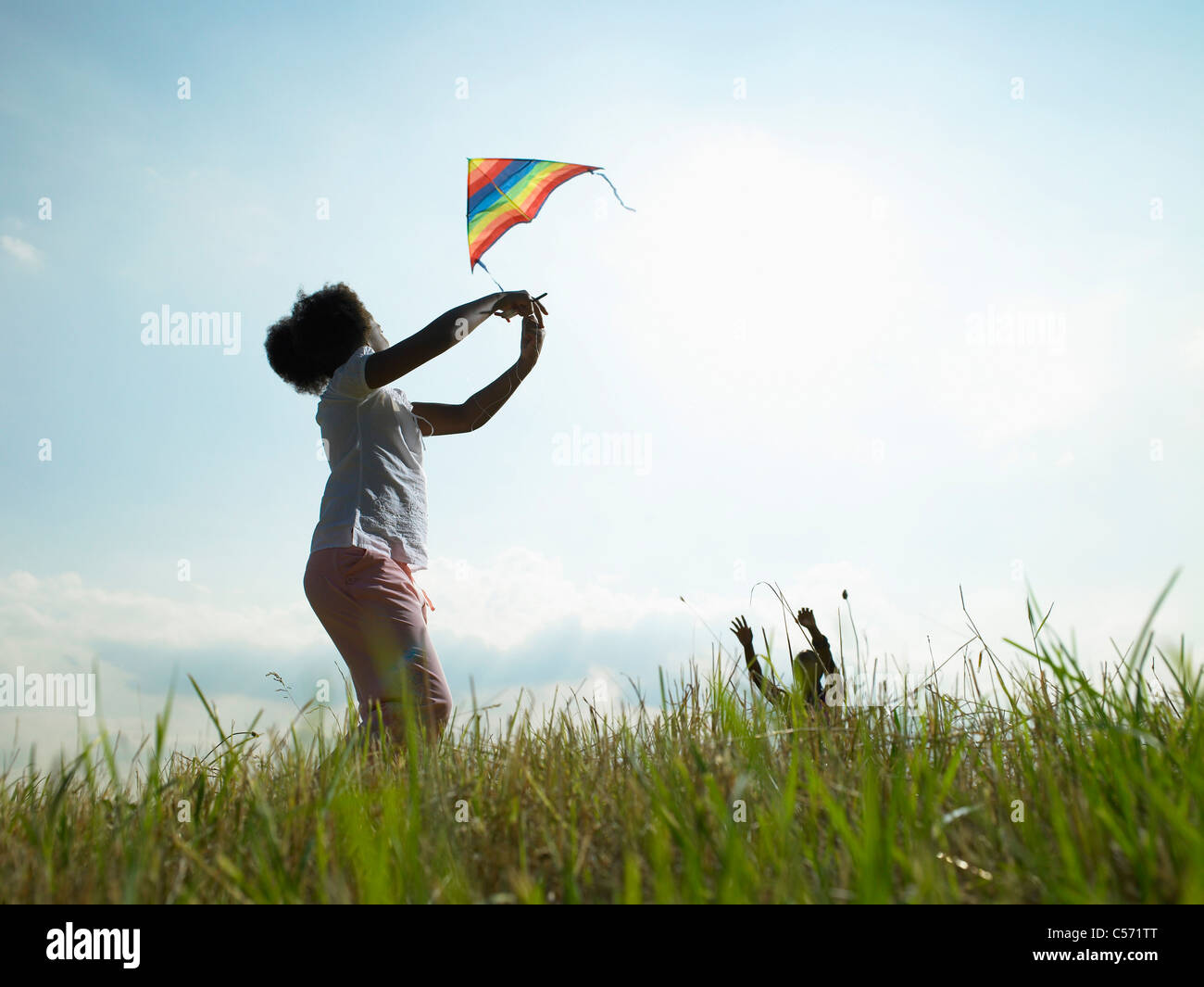 Children playing with kite in field Stock Photo - Alamy