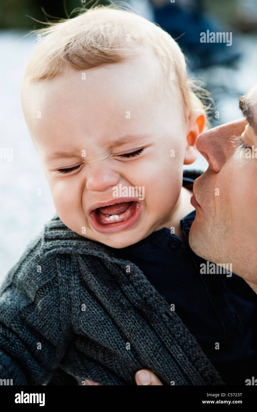 Father Kissing Crying Baby High Resolution Stock Photography and Images ...