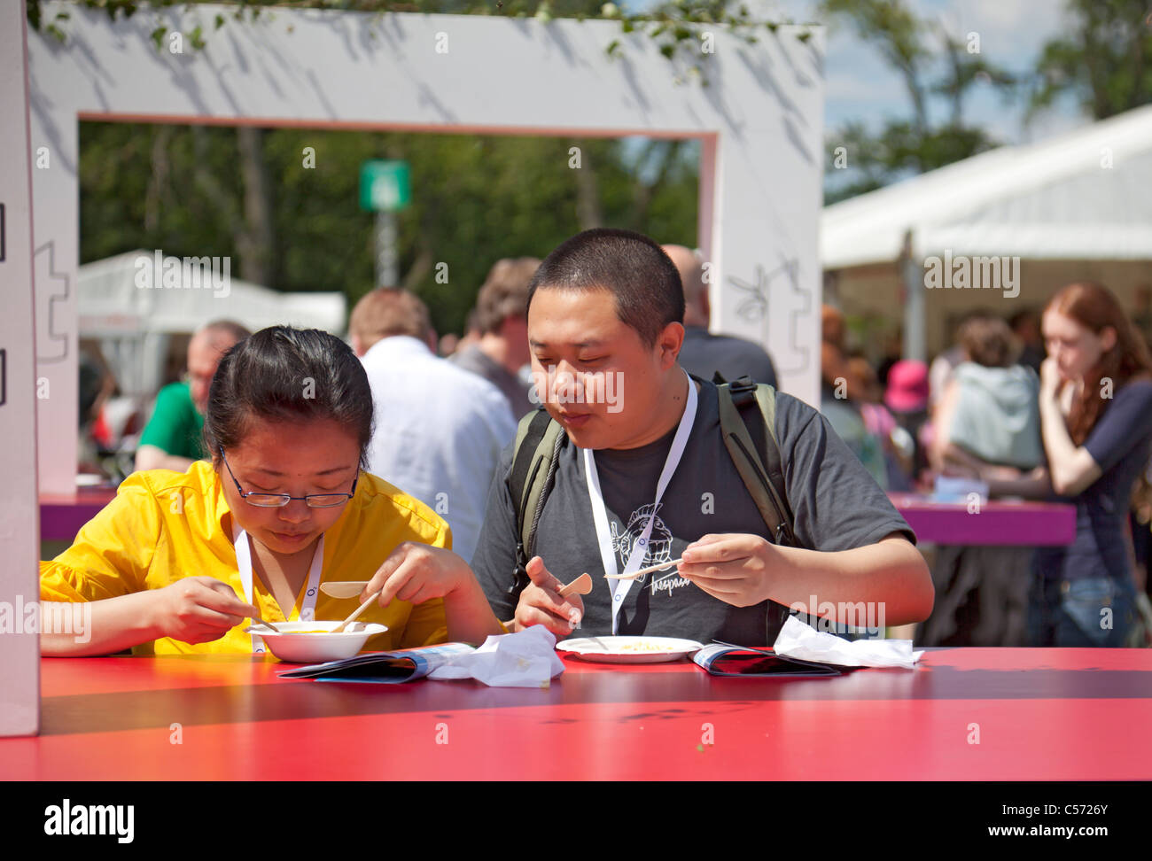 A young Asian couple sampling products from fine dining chefs at the ...