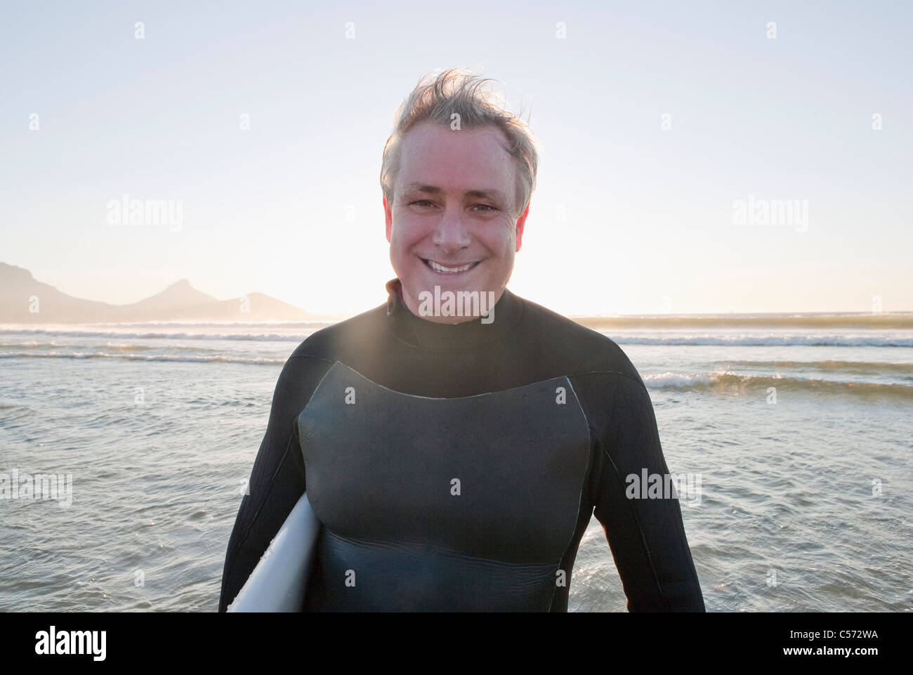 Smiling surfer in water Stock Photo - Alamy
