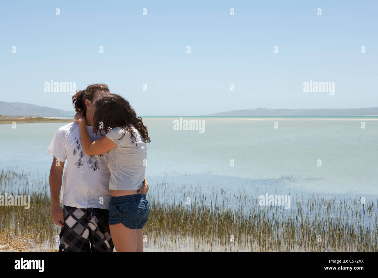 Couple kissing on beach Stock Photo - Alamy