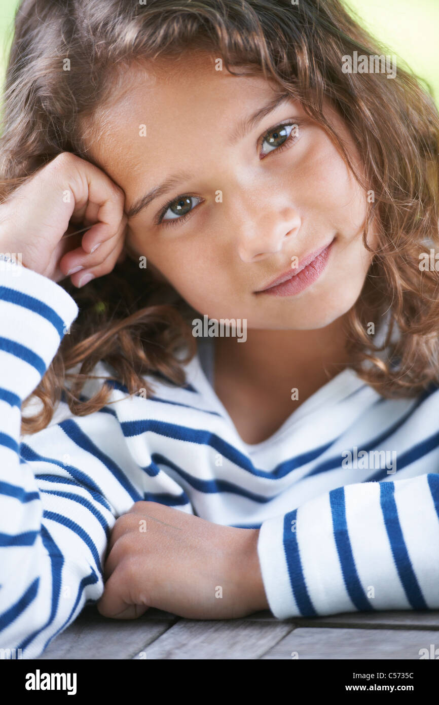 Girl resting forehead in hand Stock Photo - Alamy