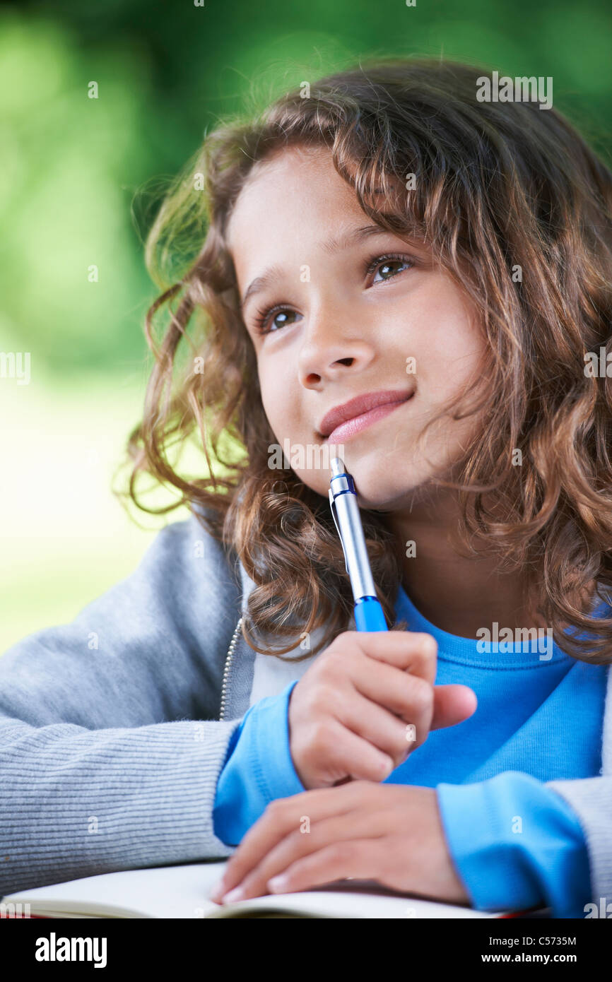Girl thinking and writing Stock Photo - Alamy