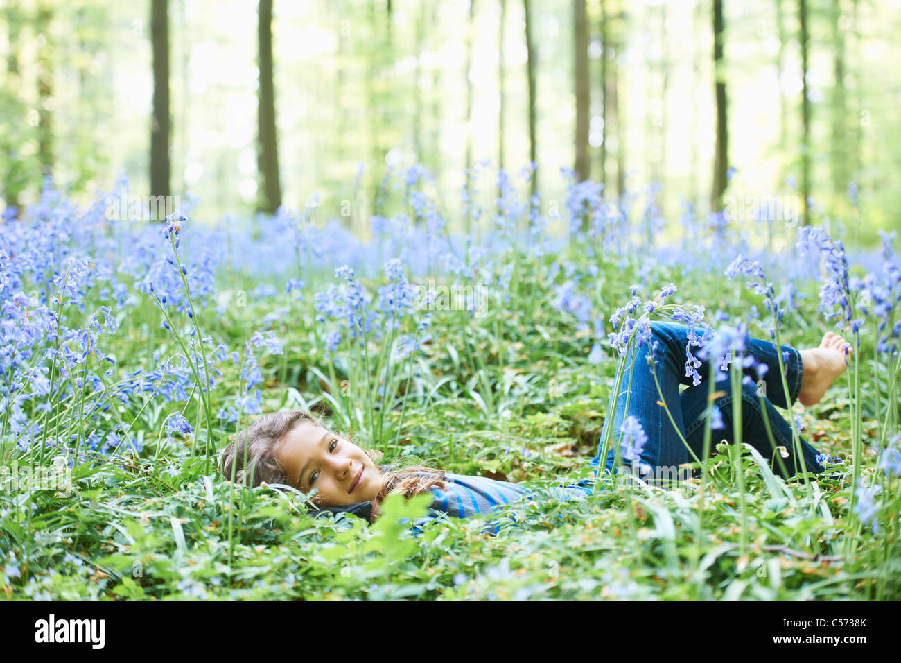 Girl laying in field of flowers Stock Photo - Alamy