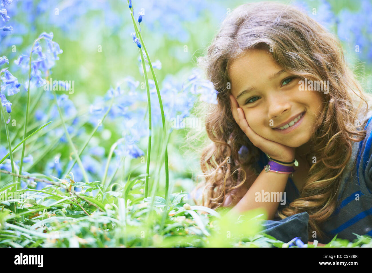 Girl laying in field of flowers Stock Photo - Alamy
