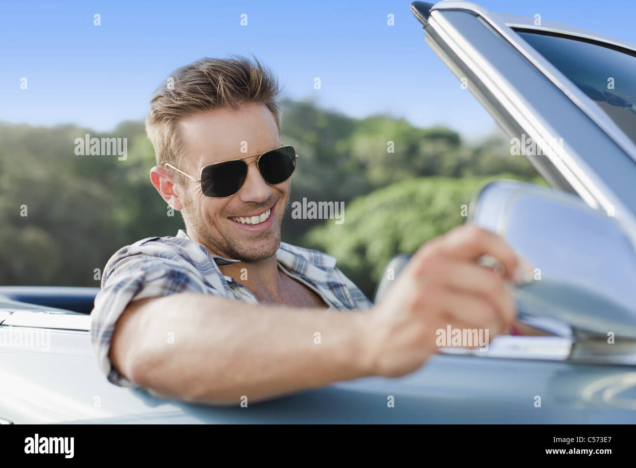 Man driving convertible Stock Photo - Alamy