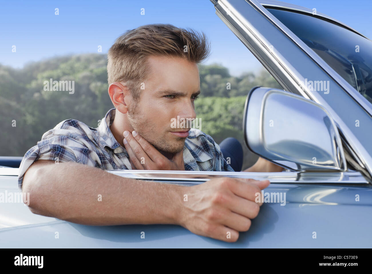 Man checking himself in car side mirror Stock Photo - Alamy