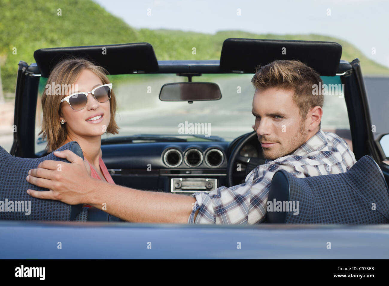 Couple riding in convertible Stock Photo - Alamy