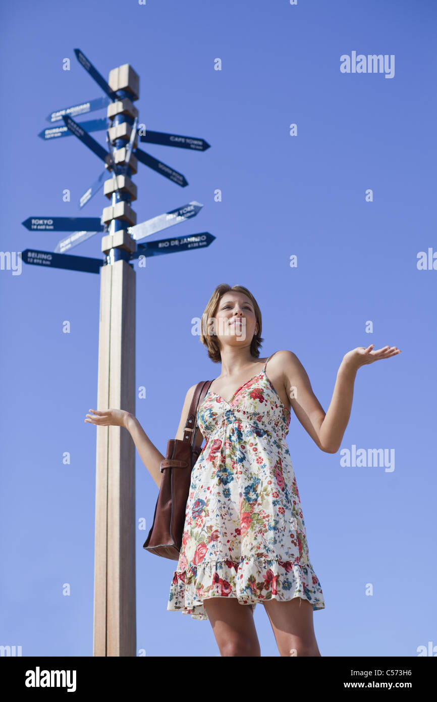 Confused woman at crossroads Stock Photo - Alamy