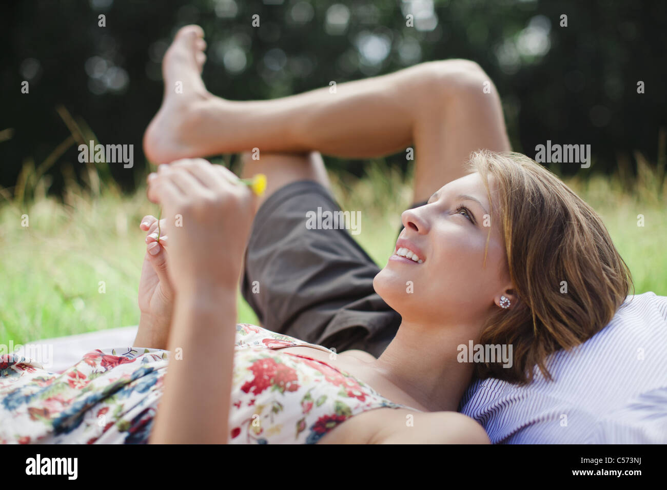 Couple laying in field together Stock Photo - Alamy