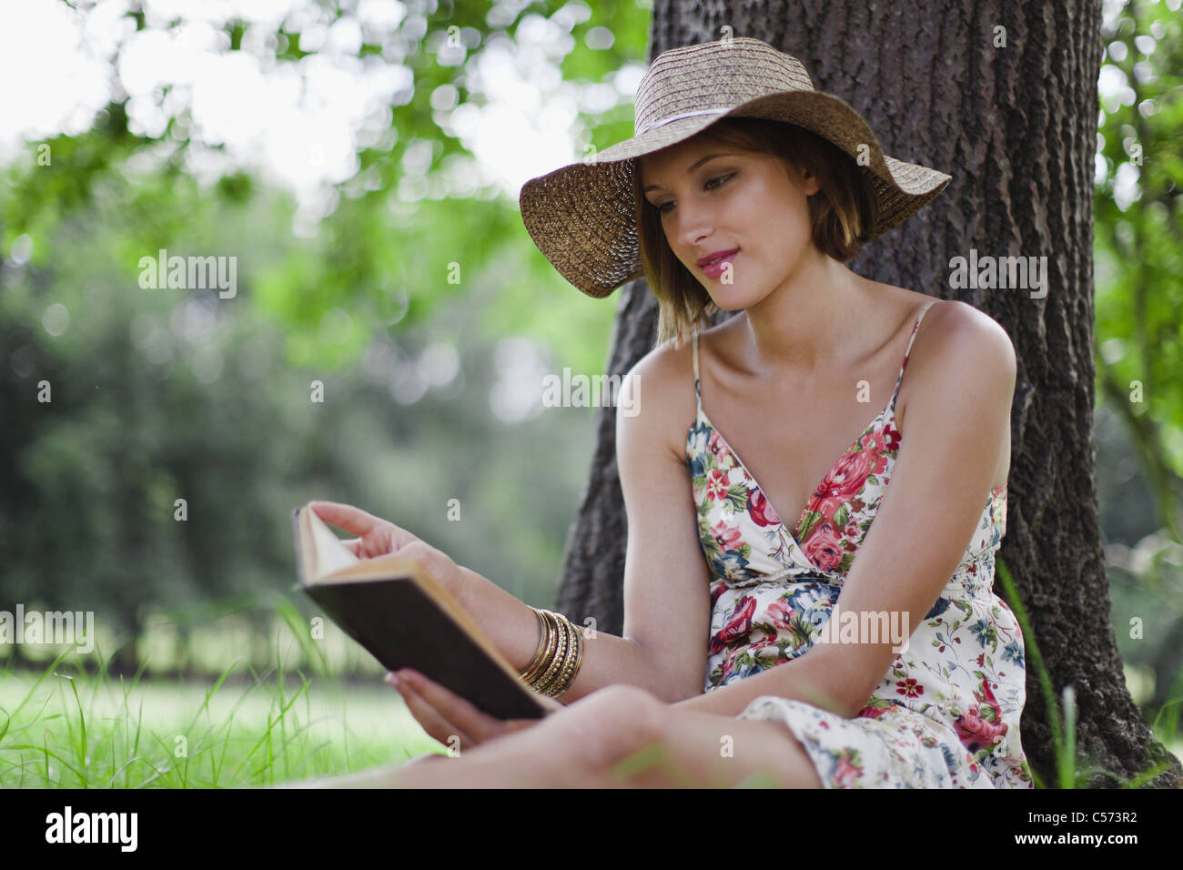 Woman Sitting Against Tree Trunk High Resolution Stock Photography and ...