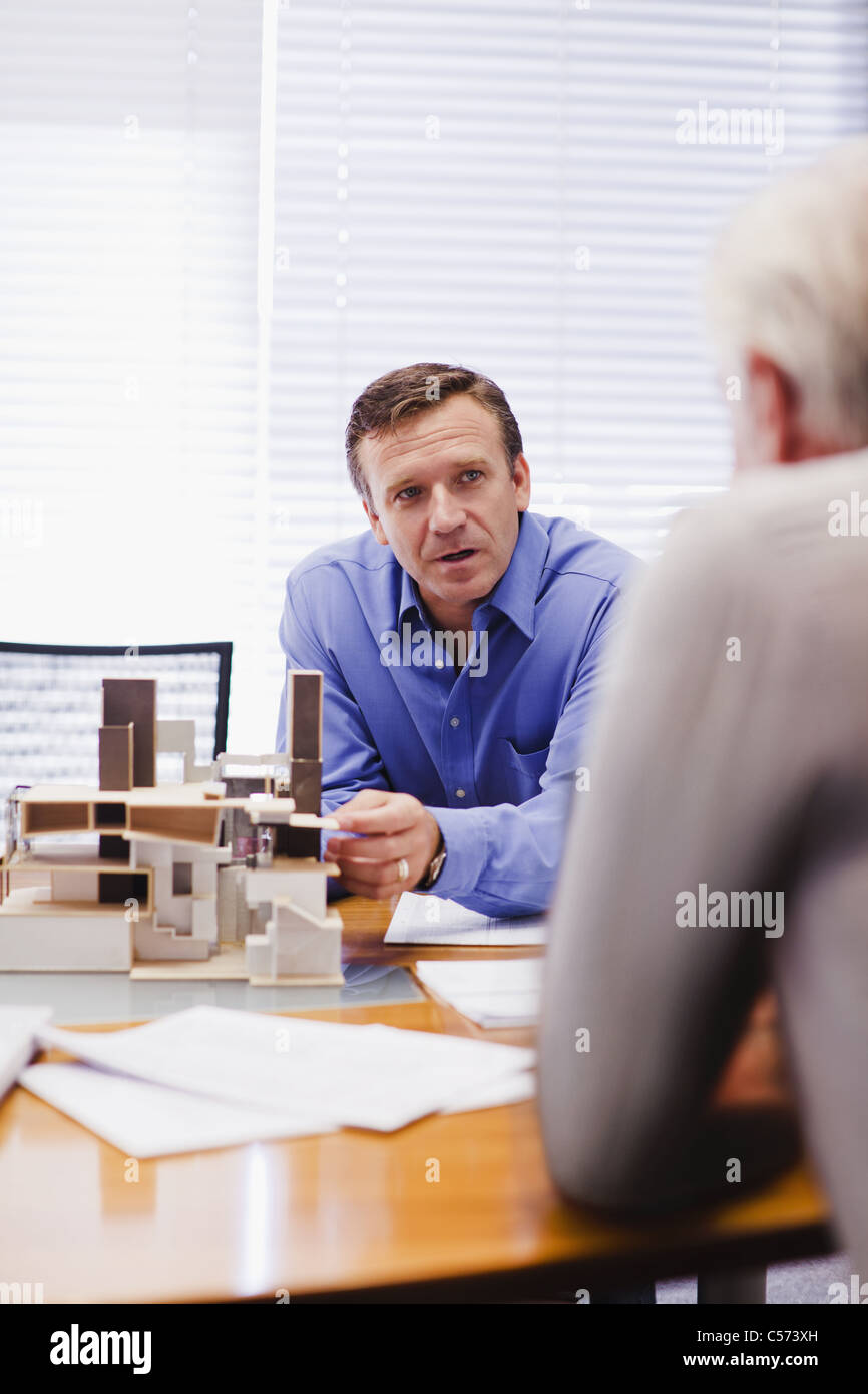 Business people examining model Stock Photo - Alamy