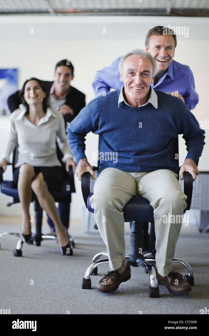 Business people having chair race Stock Photo - Alamy