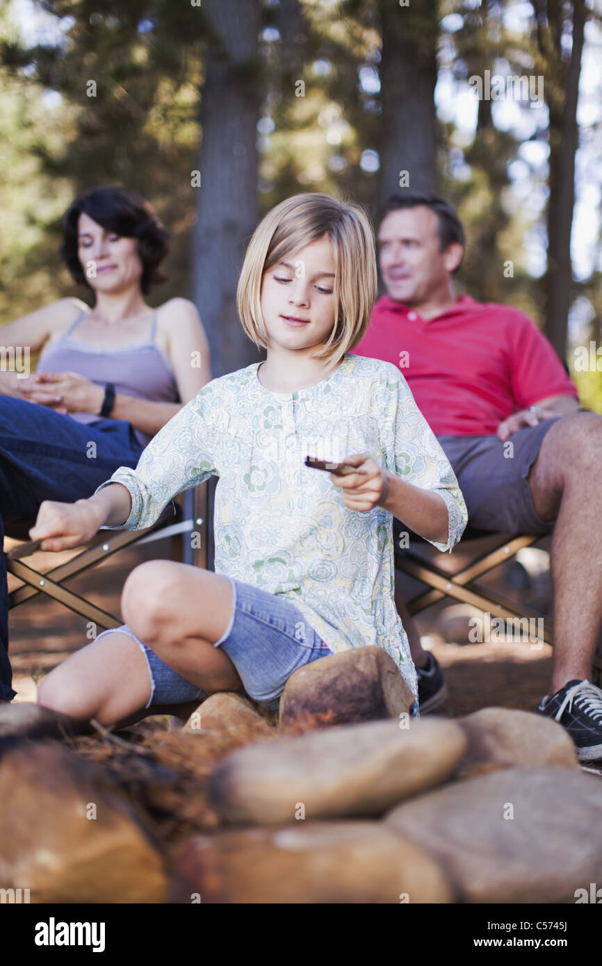 Girl starting campfire Stock Photo - Alamy