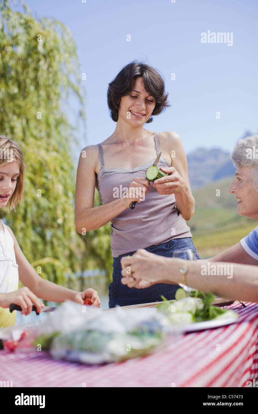 Mother making picnic lunch at table Stock Photo - Alamy