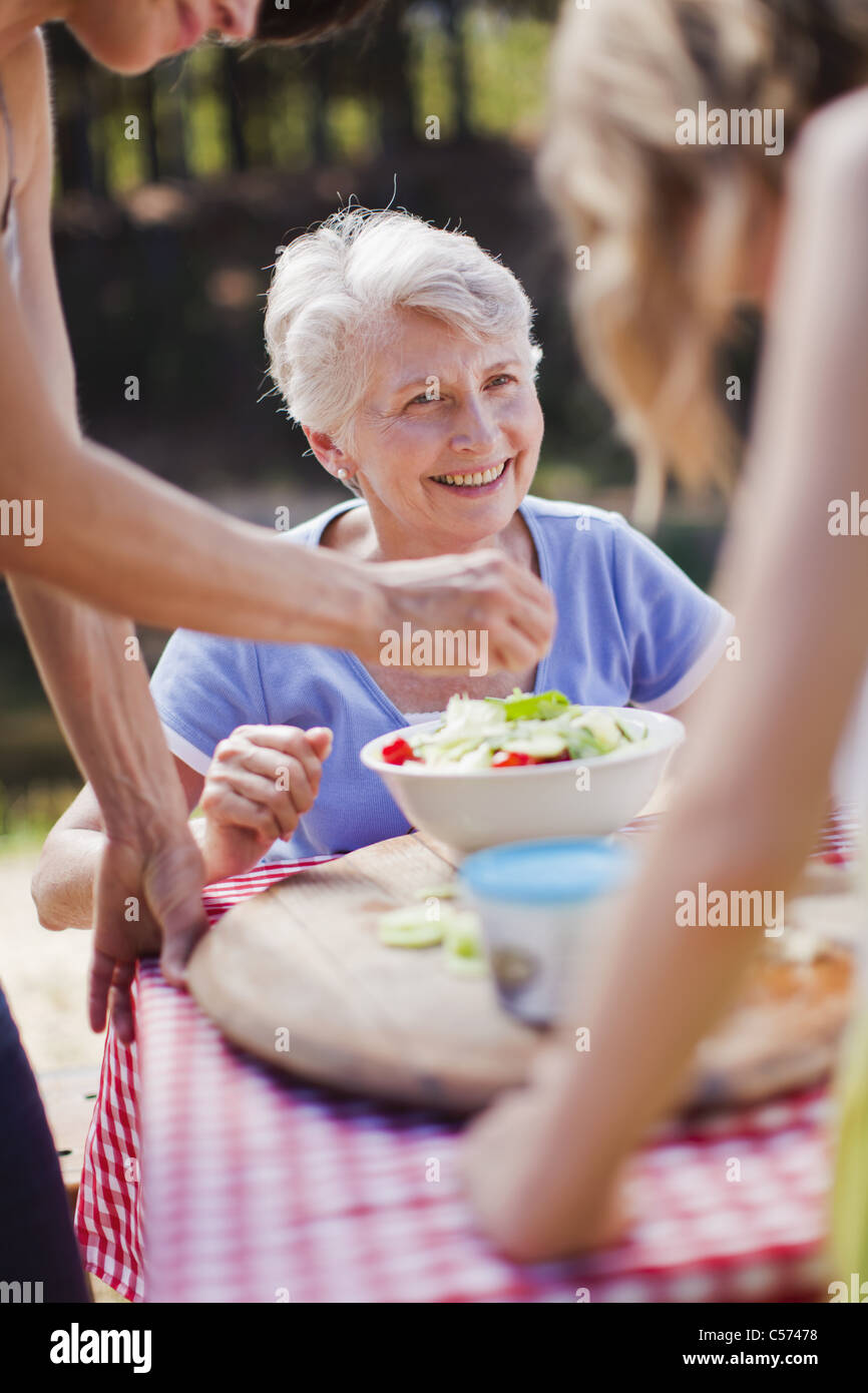 Family seated at picnic table hi-res stock photography and images - Alamy