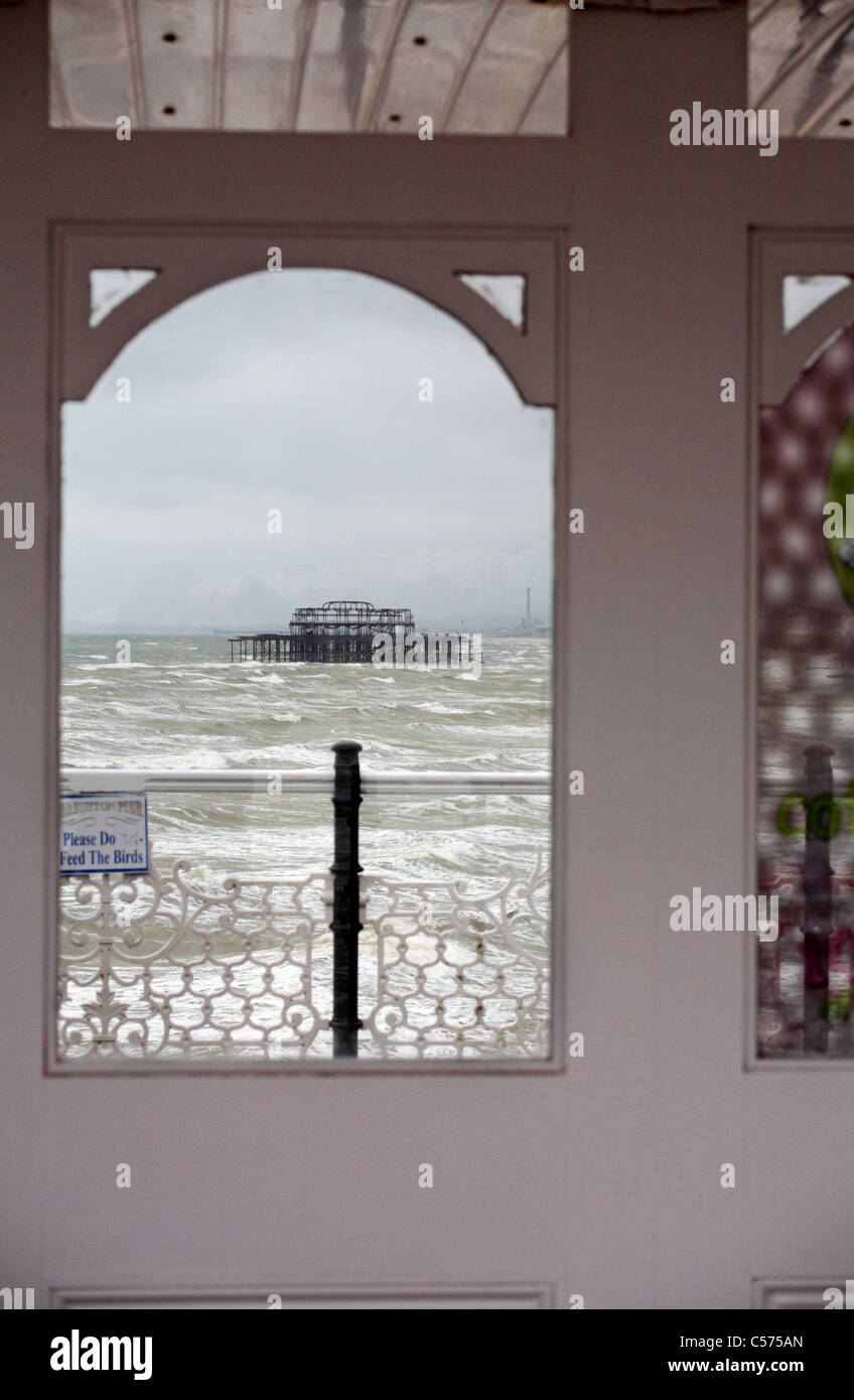 View of the old Brighton West Pier framed through a window on the new ...
