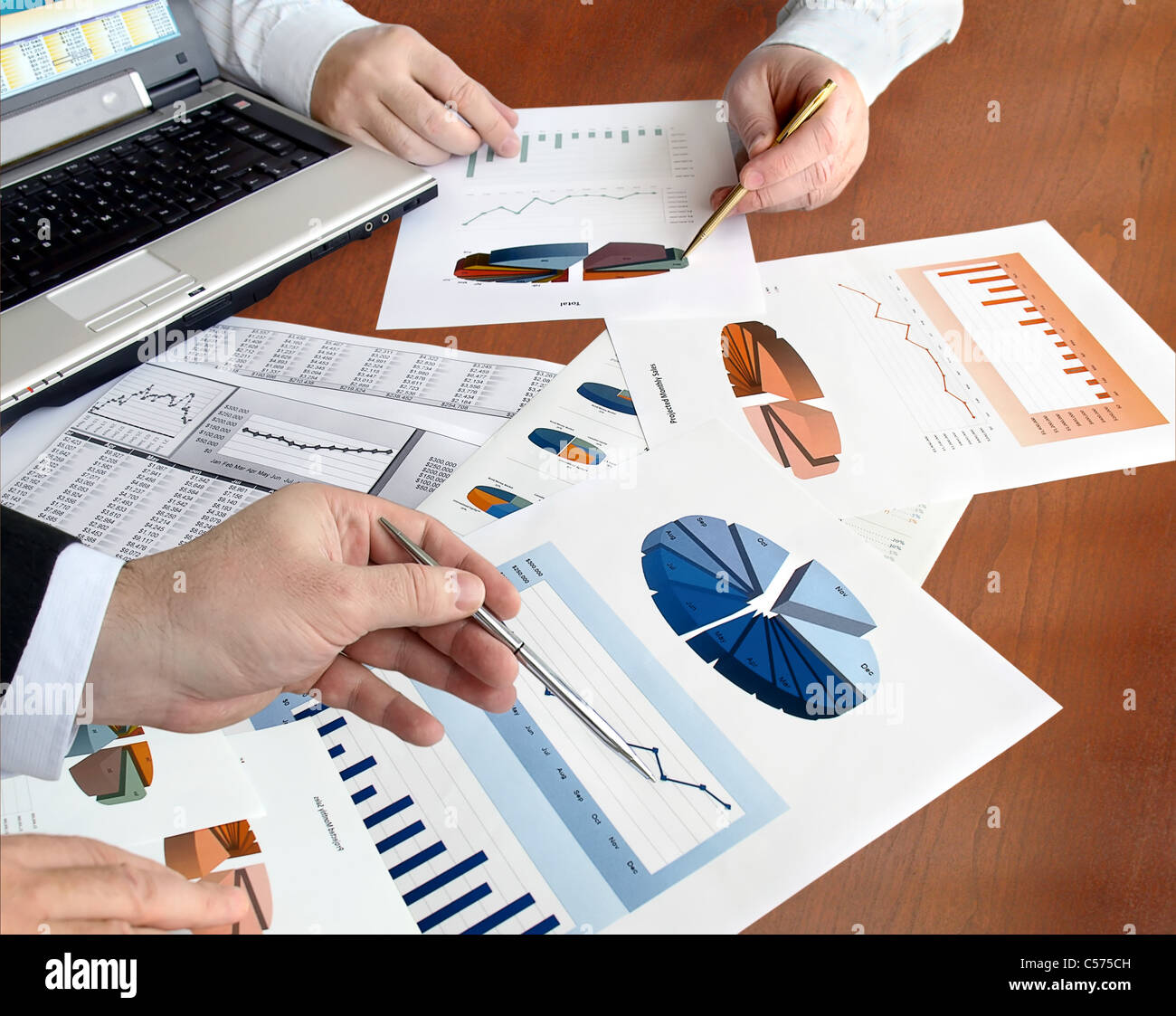 Closeup of hands with financial charts at business meeting in the ...