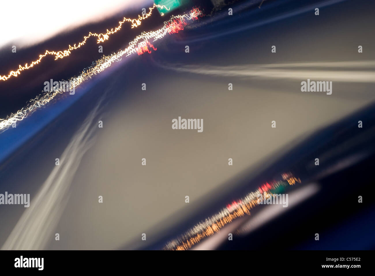 Abstract blur of a drivers view at high speed on an urban road or ...