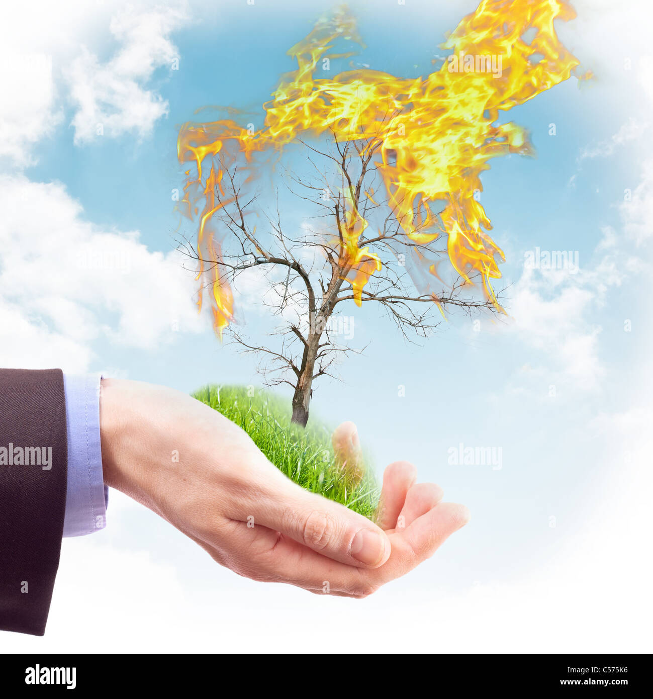 Human hand holding a piece of nature in flames. Concept of saving ...