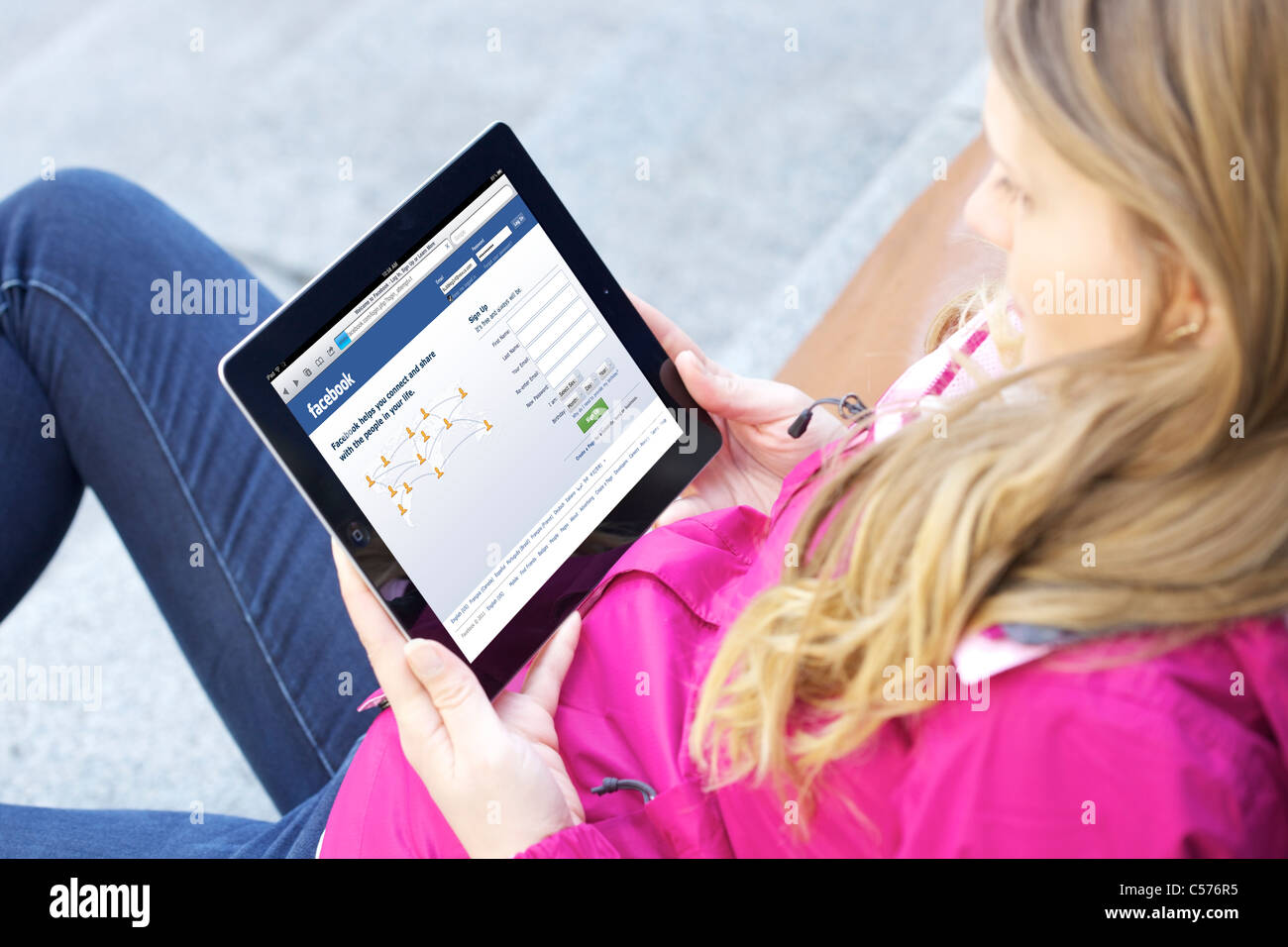 Close up picture of a young woman using Facebook social networking ...