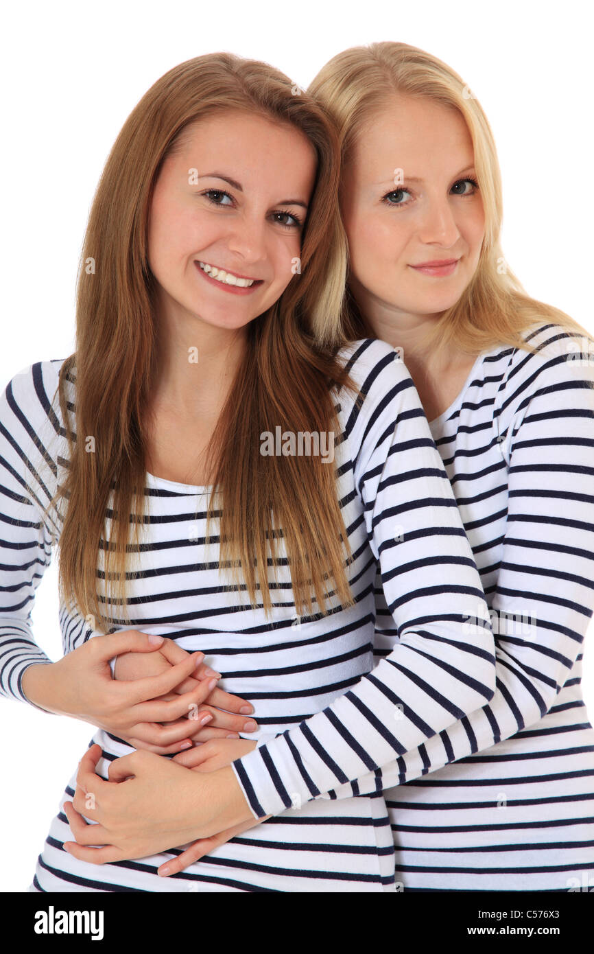 Two attractive girls hugging. All on white background Stock Photo - Alamy
