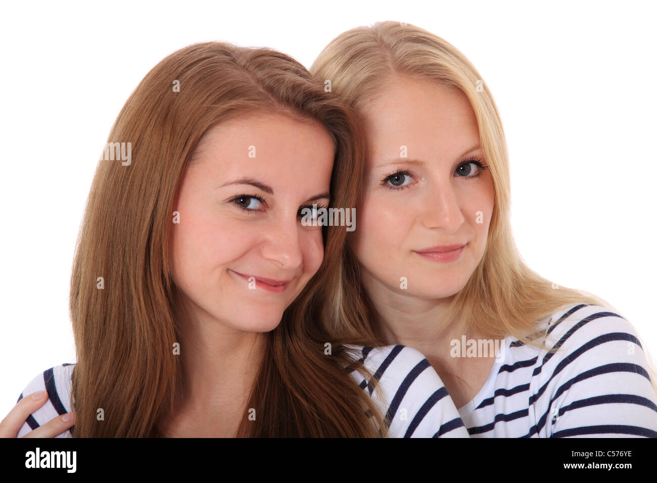 Two attractive girls hugging. All on white background Stock Photo - Alamy