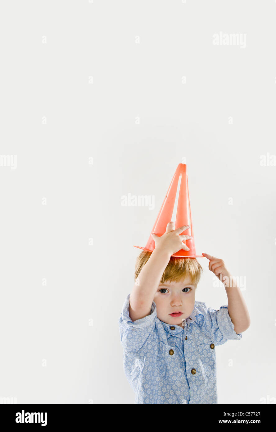 Toddler playing with traffic cone Stock Photo - Alamy