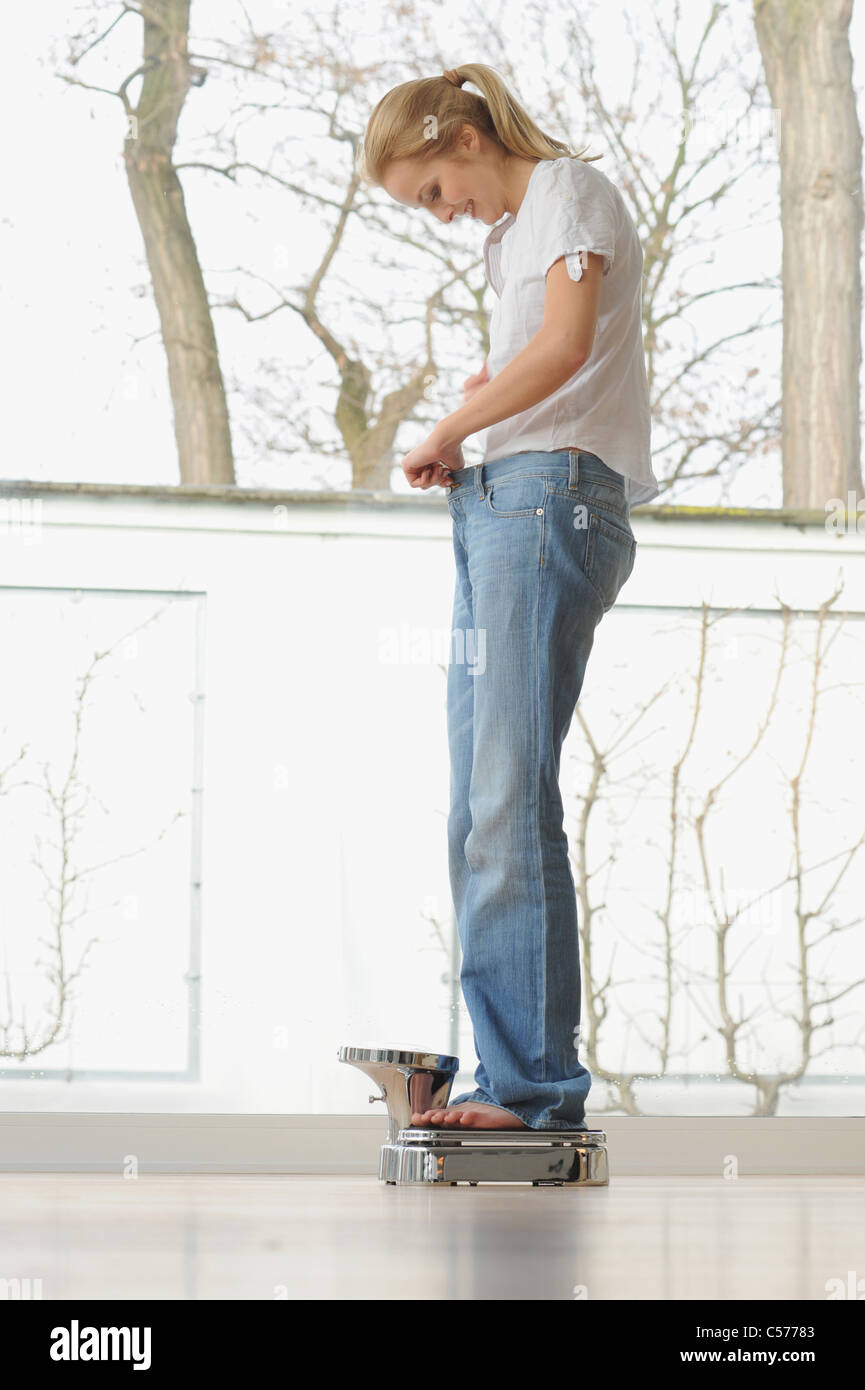 Woman pulling down pants hi-res stock photography and images - Alamy