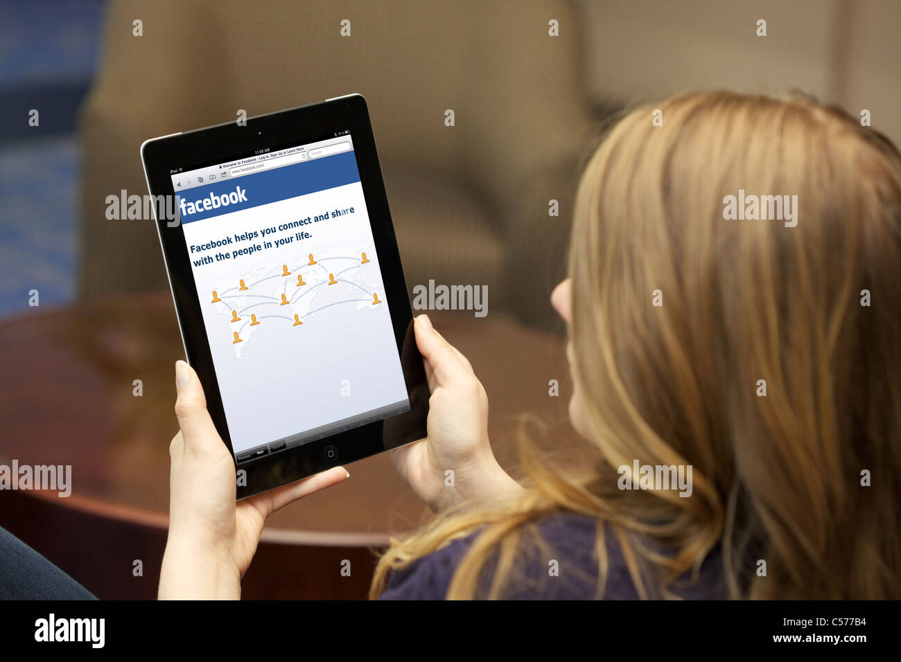 Close up picture of a young woman using Facebook social networking ...