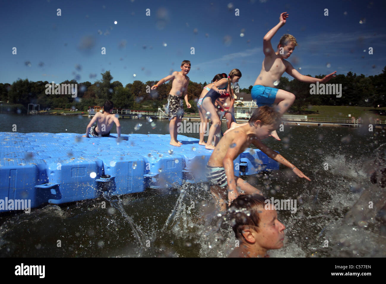 Child jumping to the water hi-res stock photography and images - Alamy