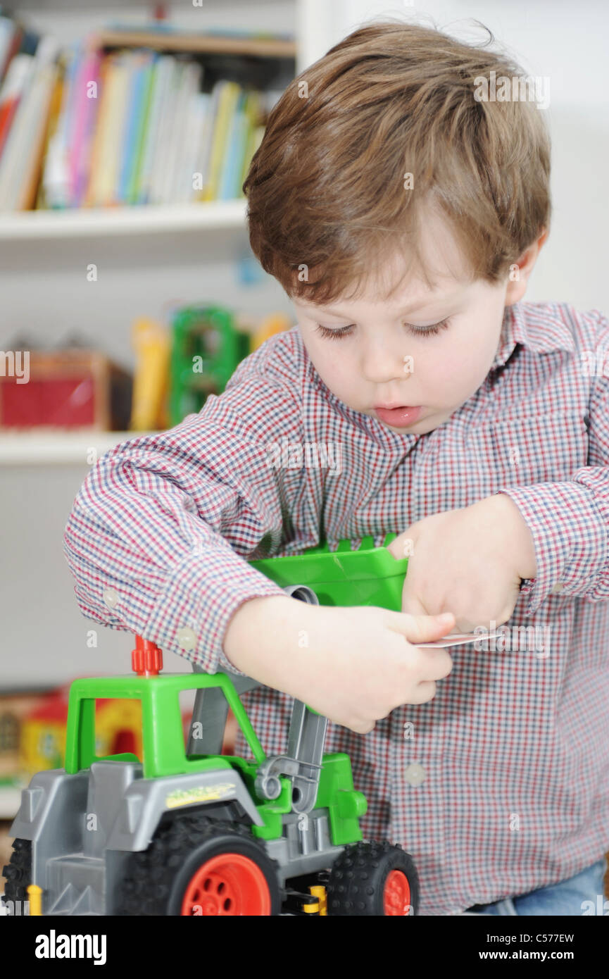 Boy playing with toys Stock Photo - Alamy