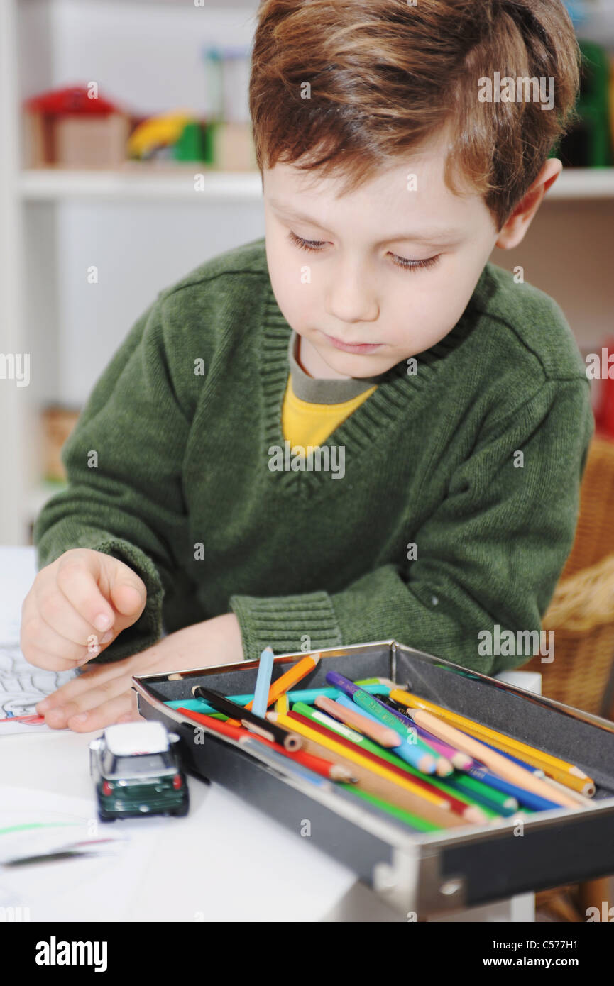 Boy drawing with colored pencils Stock Photo - Alamy