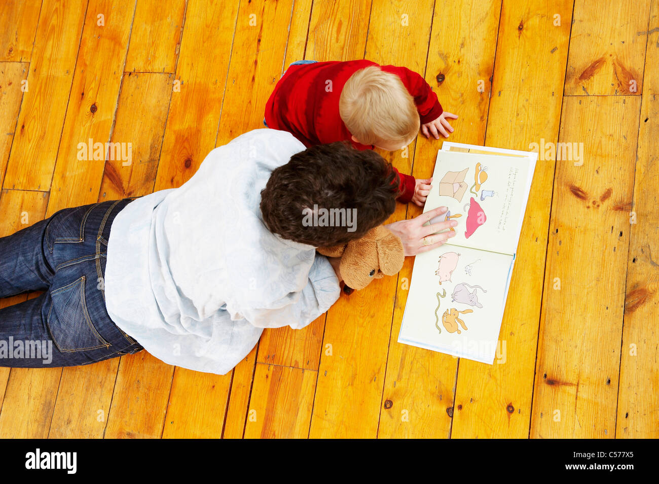 Father and son reading together Stock Photo - Alamy