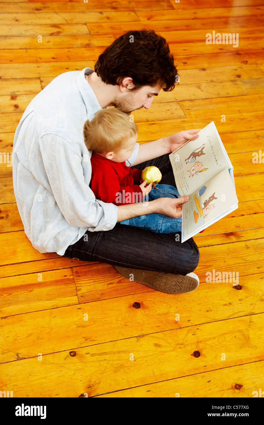 Father and son reading together Stock Photo - Alamy