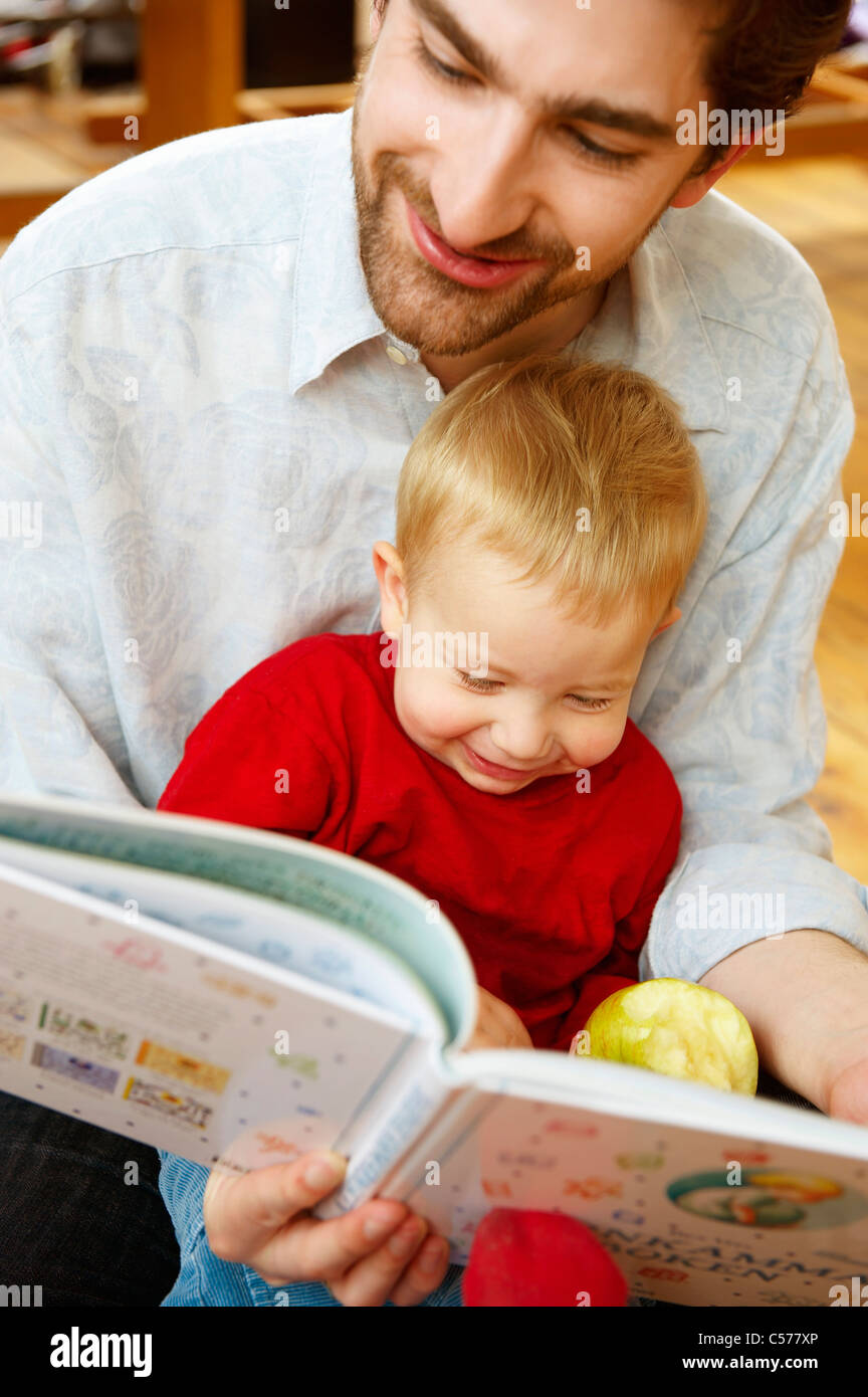 Father and son reading together Stock Photo - Alamy